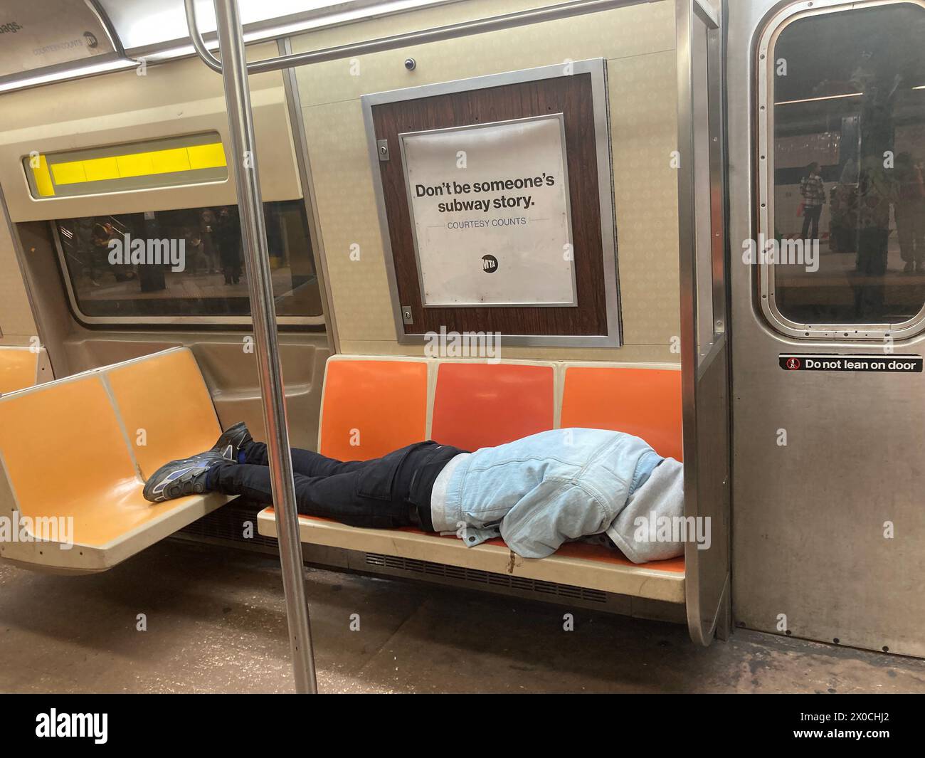 Homeless man asleep on a subway train in New York on Sunday Morning ...