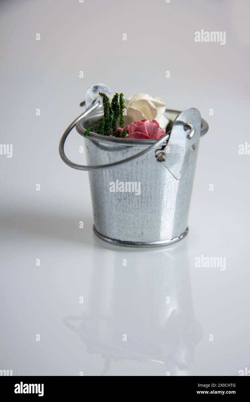 Small Still life bucket with fabric flowers Stock Photo - Alamy