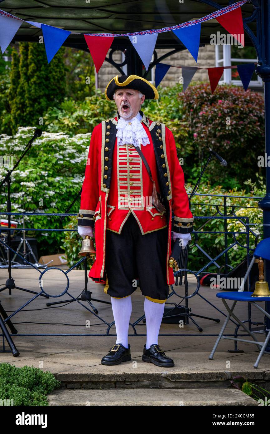 Male town crier (colourful red braided crier's livery) proclaiming ...