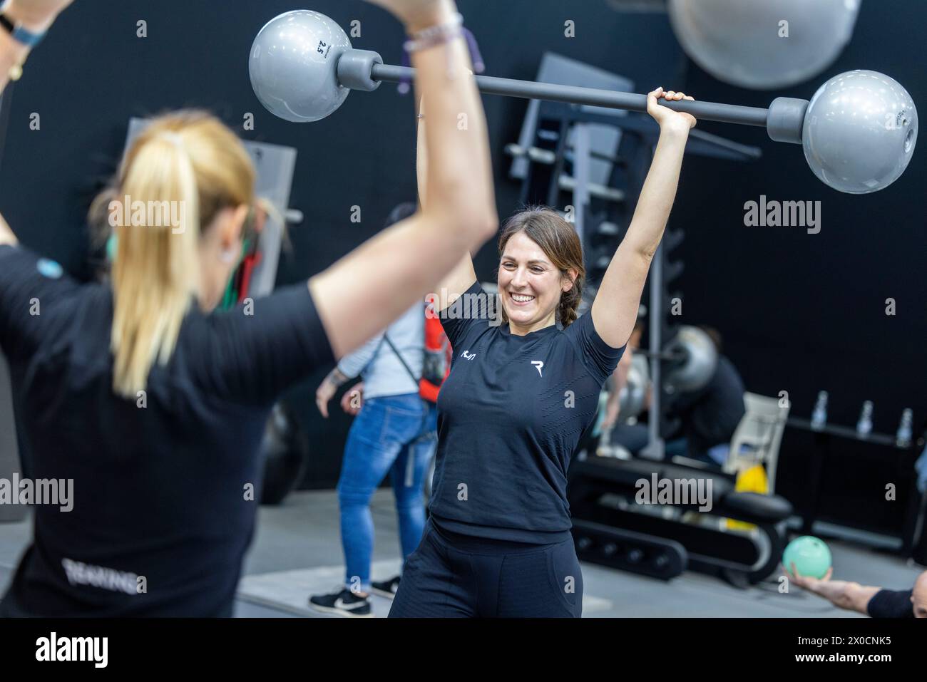 Cologne, Germany. 11th Apr, 2024. Models perform a muscle workout at a ...