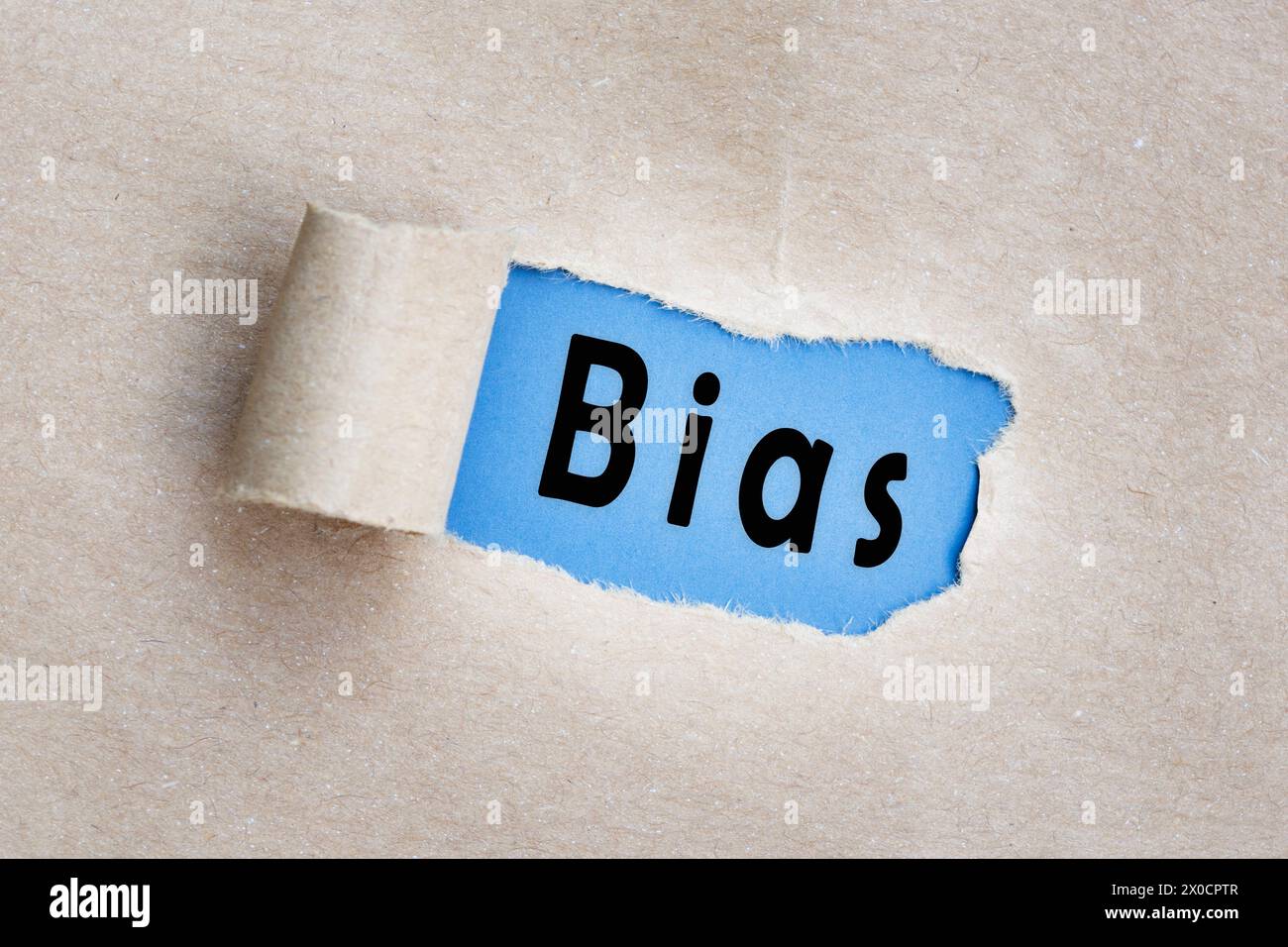 Bias text on brown paper with torn hole and rolled edge Stock Photo - Alamy