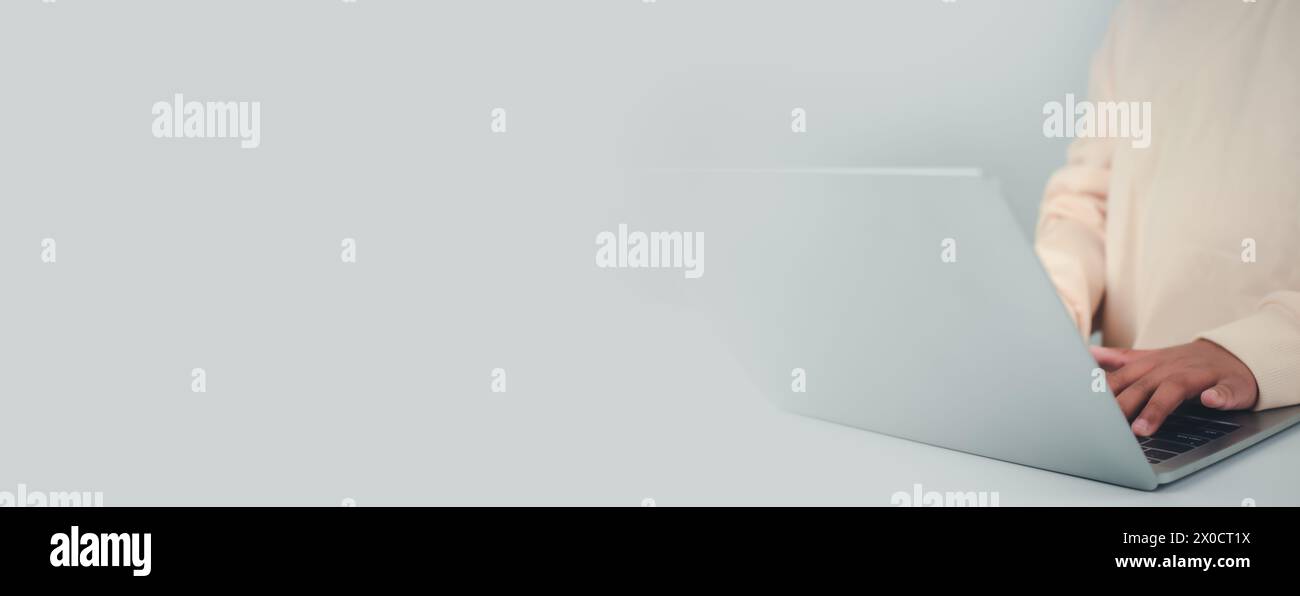 Young businessman hand typing on laptop computer while working in white ...