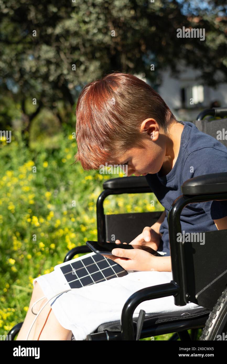 Caucasian 8 year old boy with physical disability in a wheelchair using ...