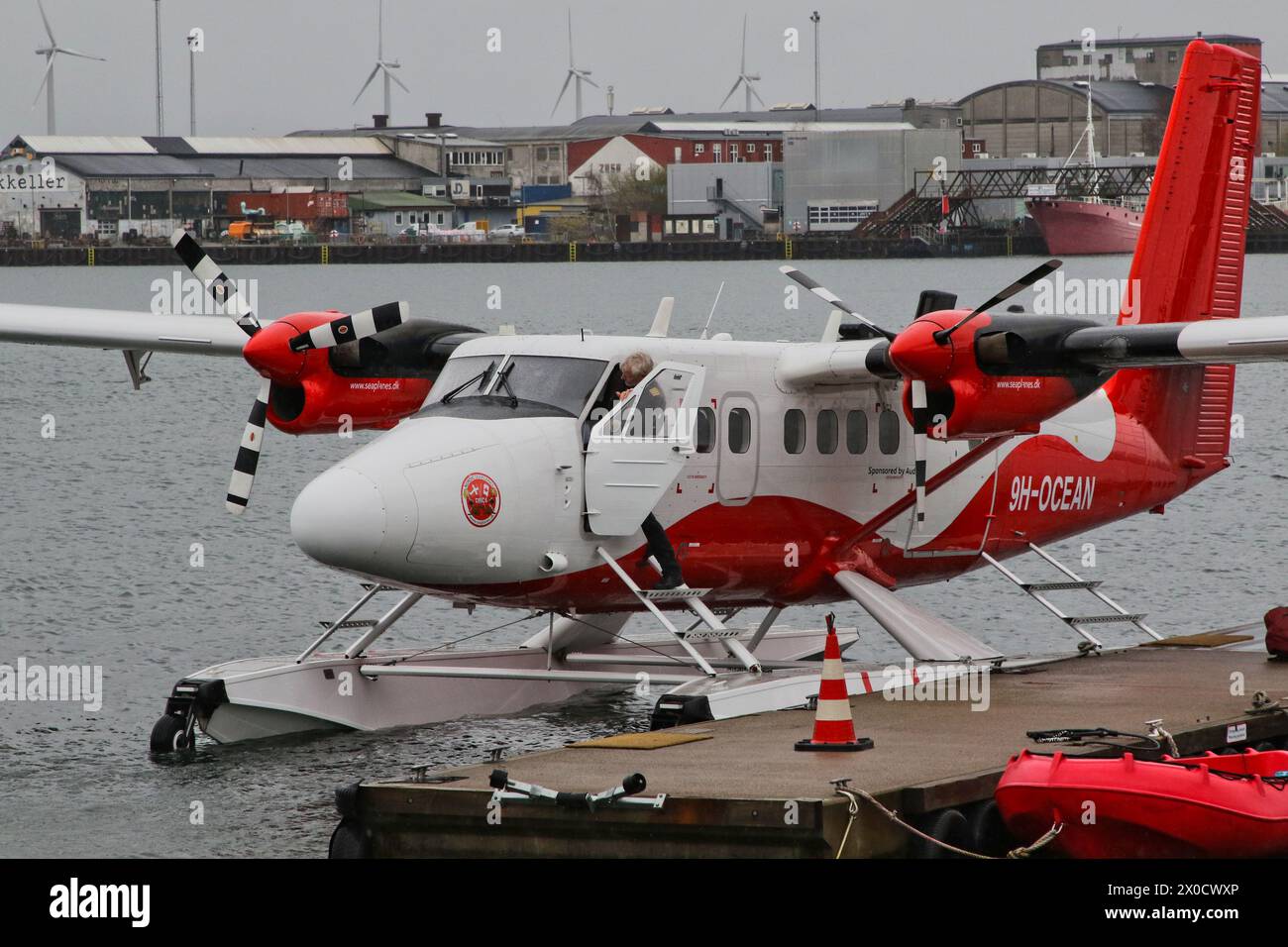 Pilot boarding red and white seaplane Copenhagen Denmark April 2024 ...