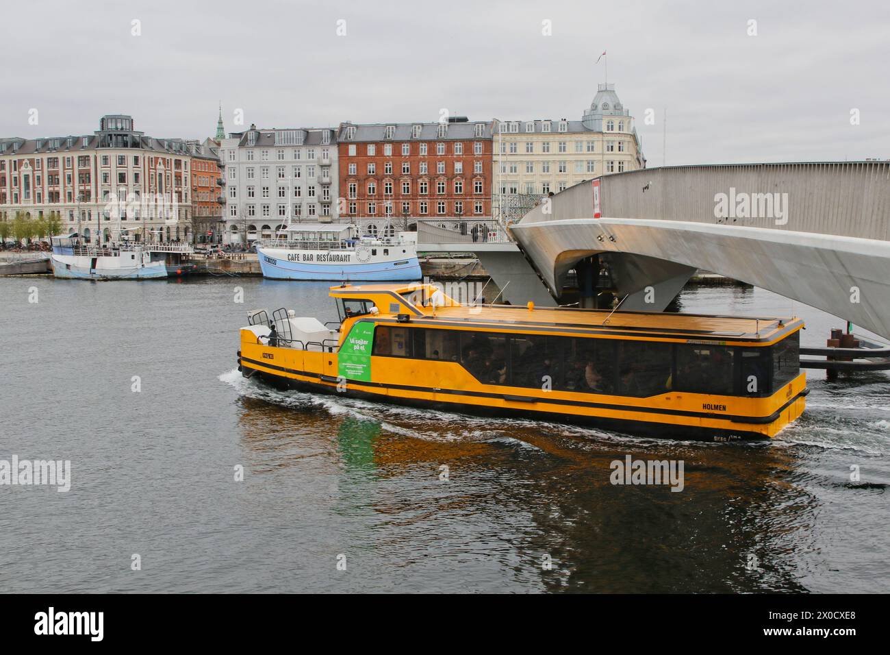 Yellow Boat bus passing under Inderhavnsbroen bridge Copenhagen Denmark ...