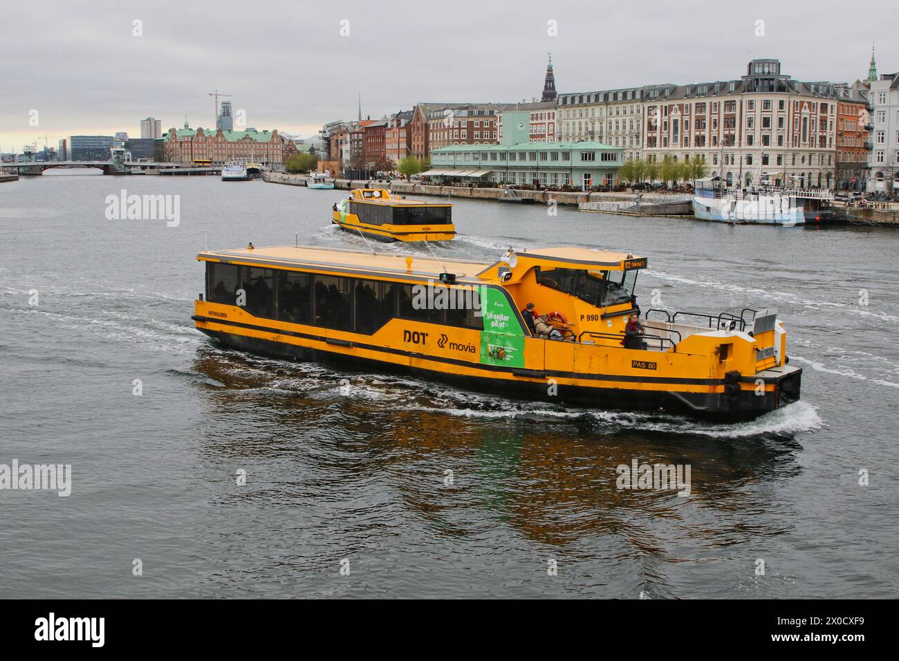 Two yellow boat bus passing in Copenhagen Harbour Denmark April 2024 ...