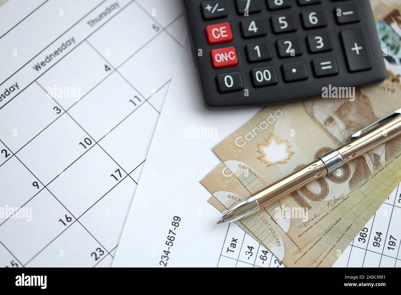 Many calculation results in schedules lies on table with canadian money ...