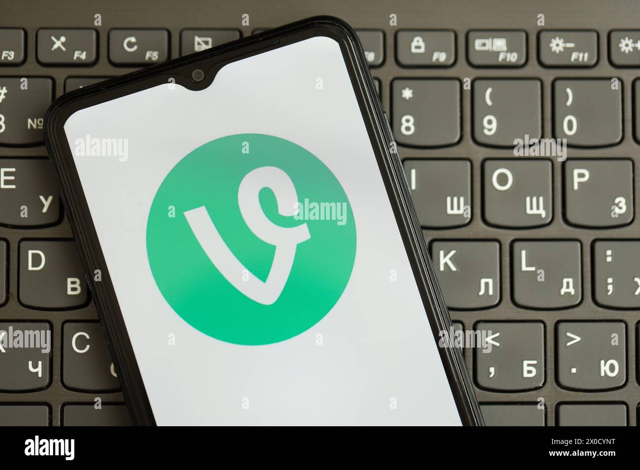 KYIV, UKRAINE - APRIL 1, 2024 Vine icon on smartphone screen on black keyboard close up. iPhone ...