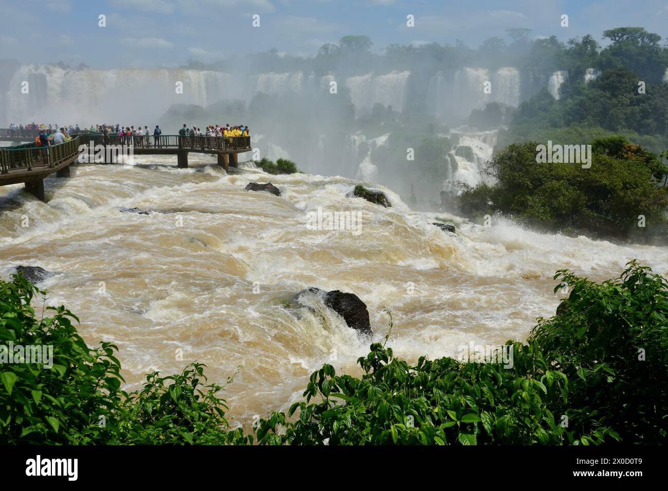 Visitors looking out over the powerful Iguazu Waterfalls at their ...