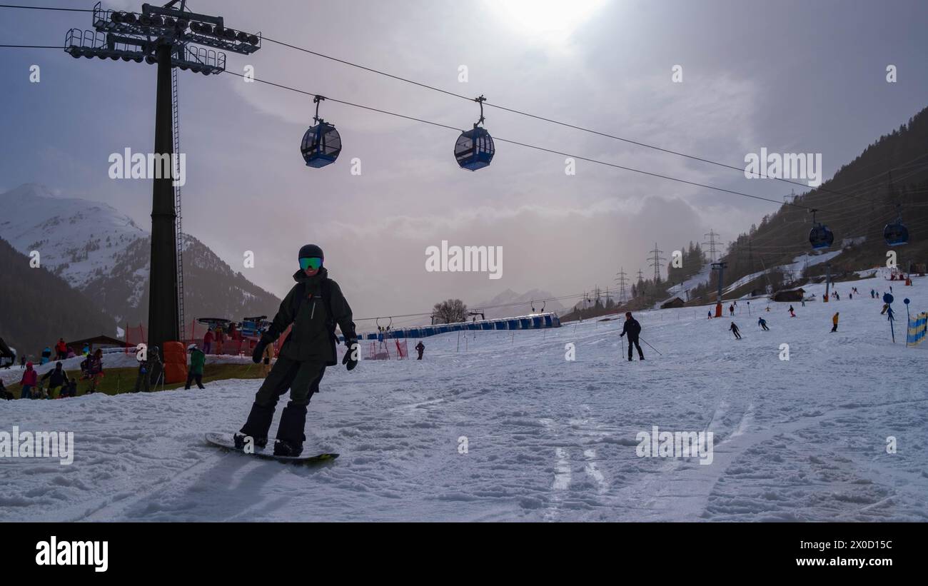 Female snowboarder reaching the bottom of nasserein piste, below ...