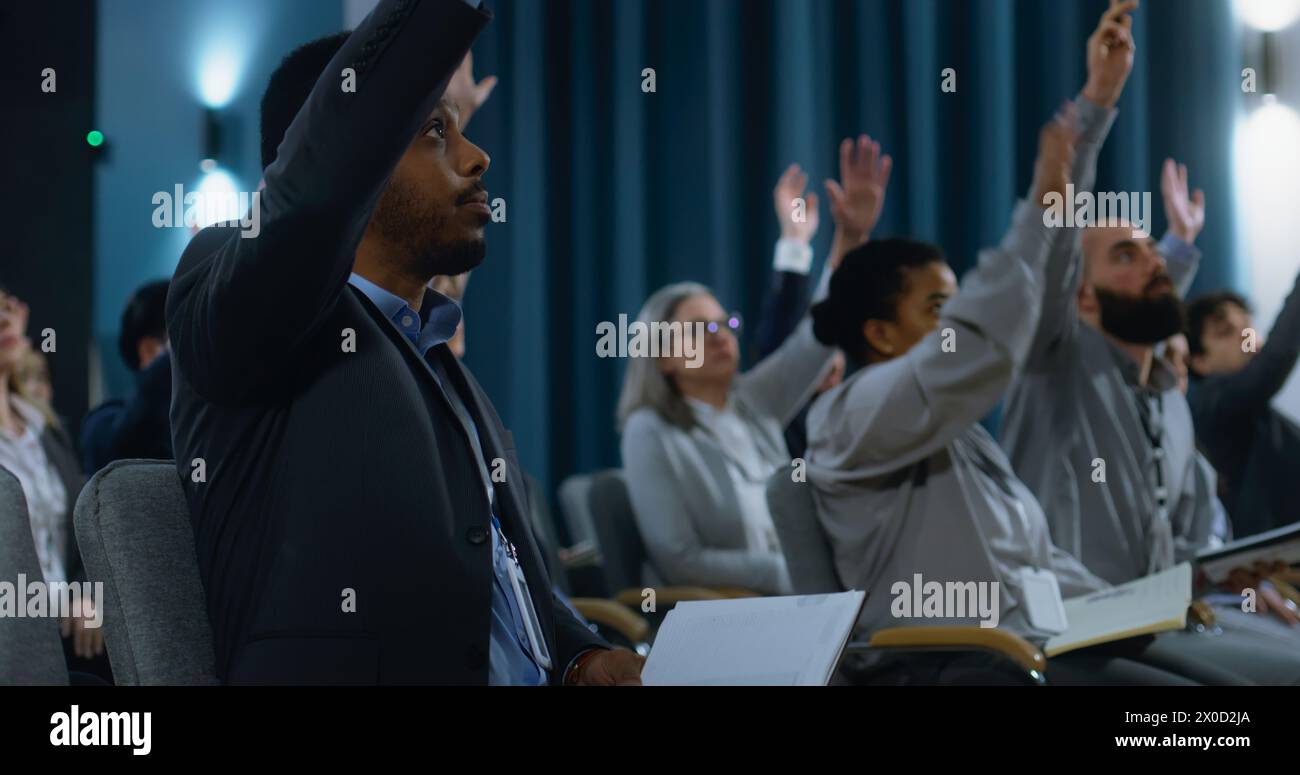 Multiethnic journalists sit and write answers from organization ...