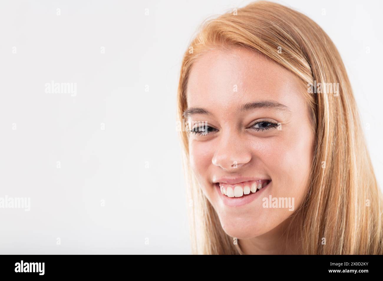 Blonde-haired young woman beams with a genuine, heartfelt smile Stock ...