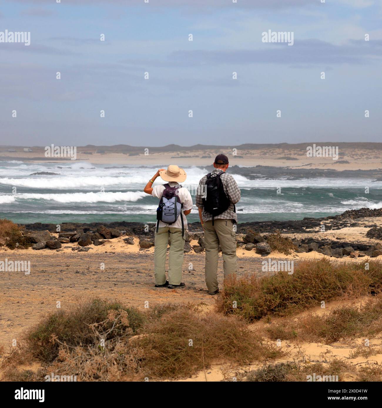 Mature couple walking along coast at Punta Tostón, El Cotillo ...