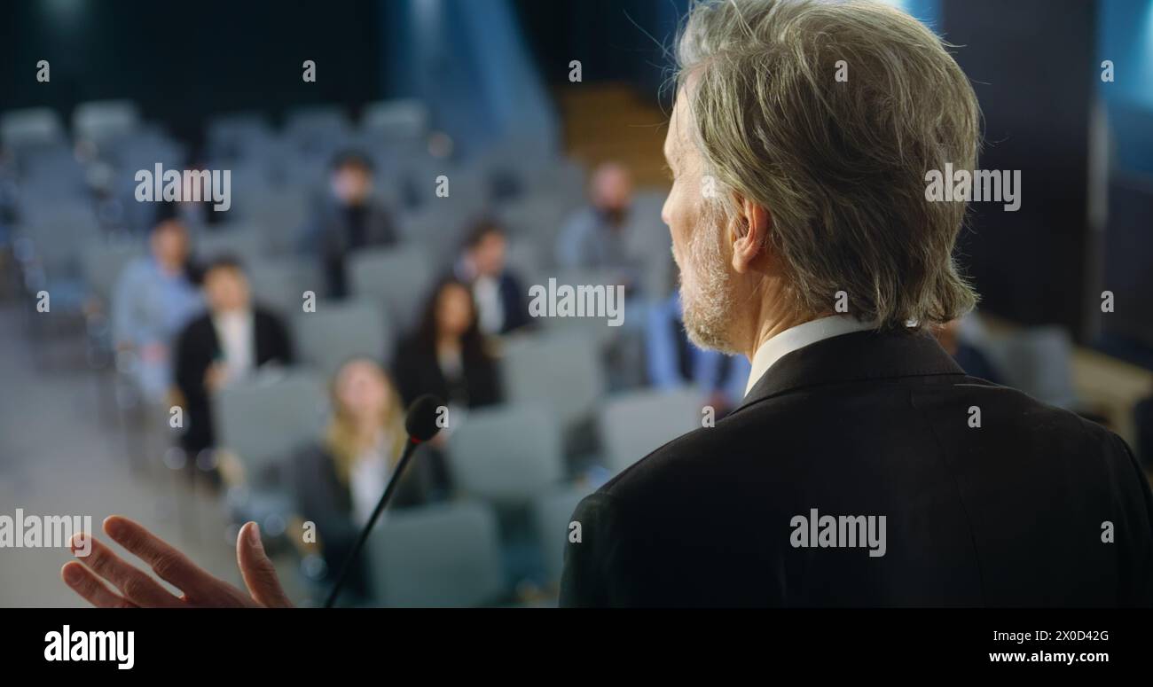 Back view of politician or activist pronouncing speech during press ...