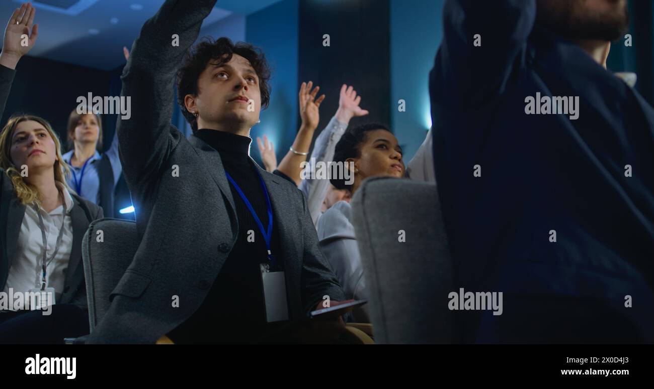 Multiethnic press workers raise hands sitting in the conference room of ...