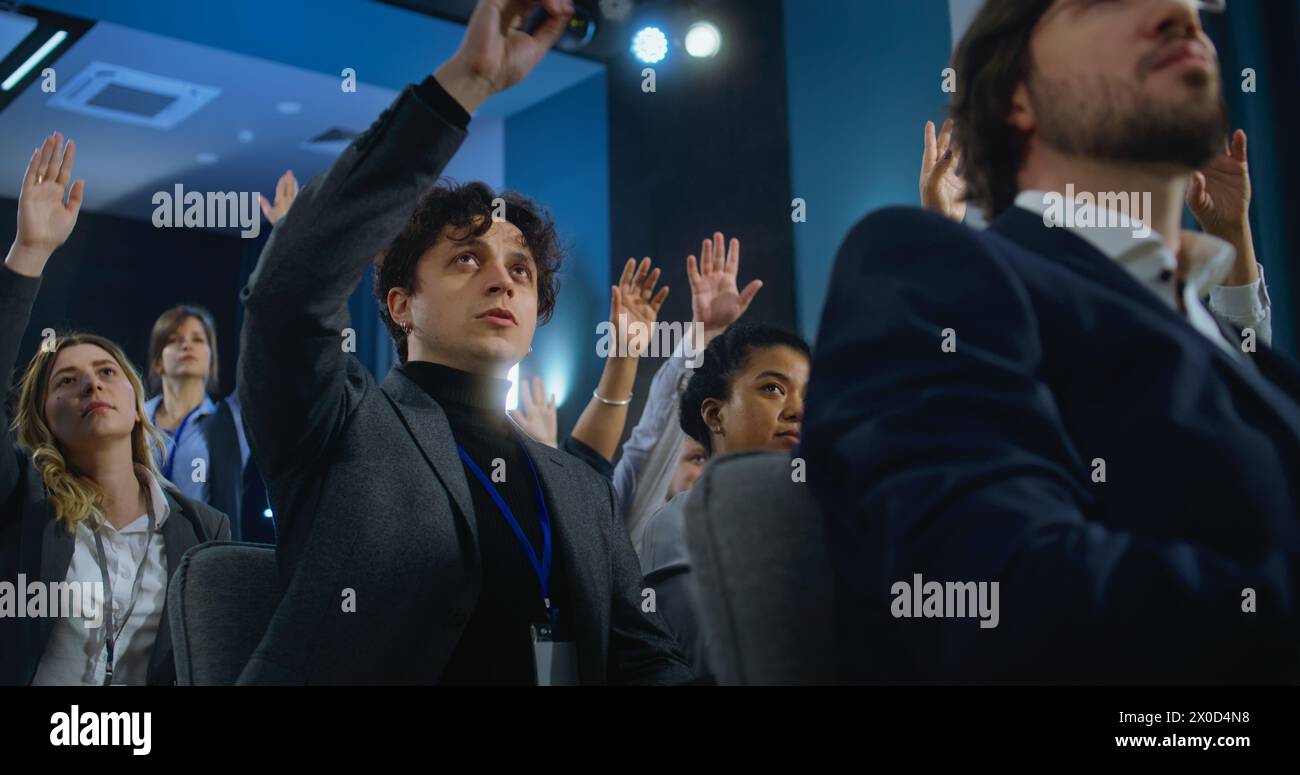 Multiethnic press workers raise hands sitting in the conference room of ...