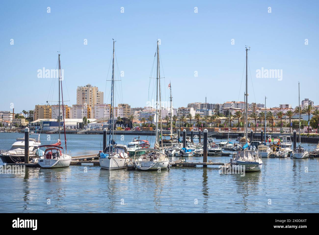View of Docks with several anchored boats on the city of Portimao ...