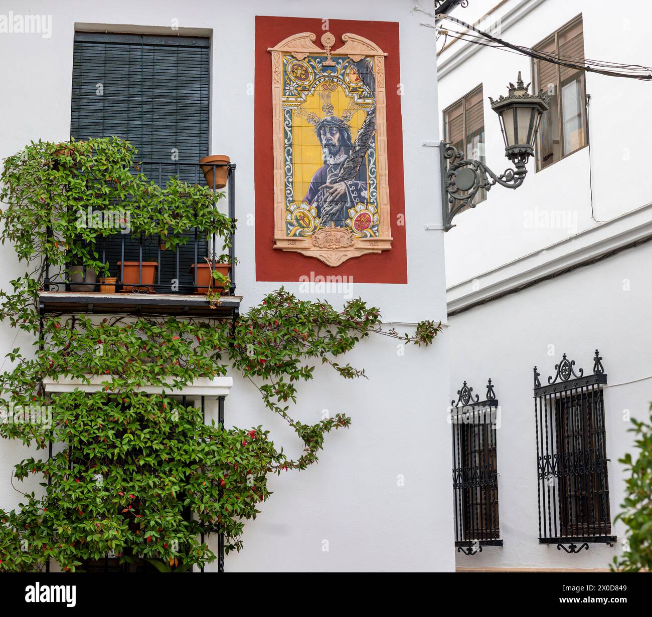 Religious azulejo tiles of Jesus Christ on a building in Andalusia ...