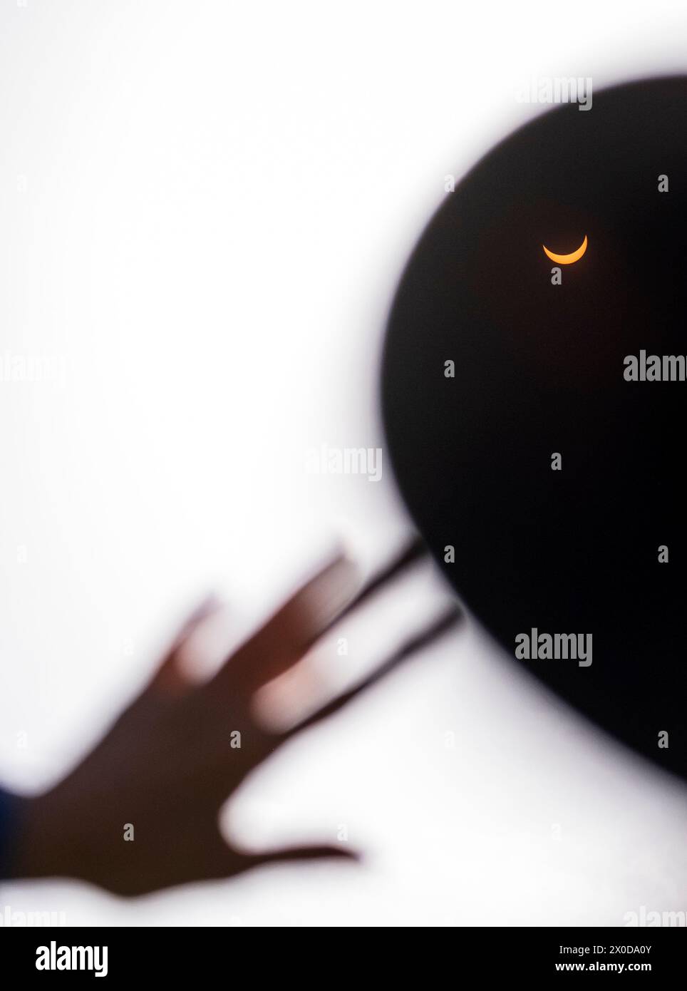 Hand reaching up to touch a total solar eclipse Stock Photo - Alamy