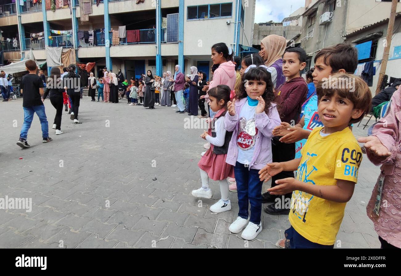 Palestinian children spend time playing on swings Inside a shelter ...