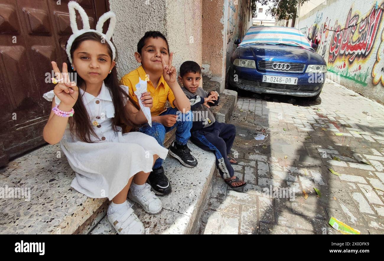 Palestinian children spend time playing on swings Inside a shelter ...