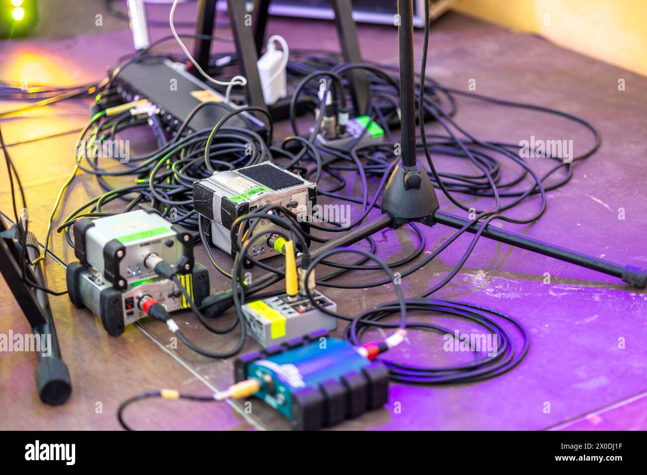Confusion of cables and boxes and musical equipment on a live stage ...