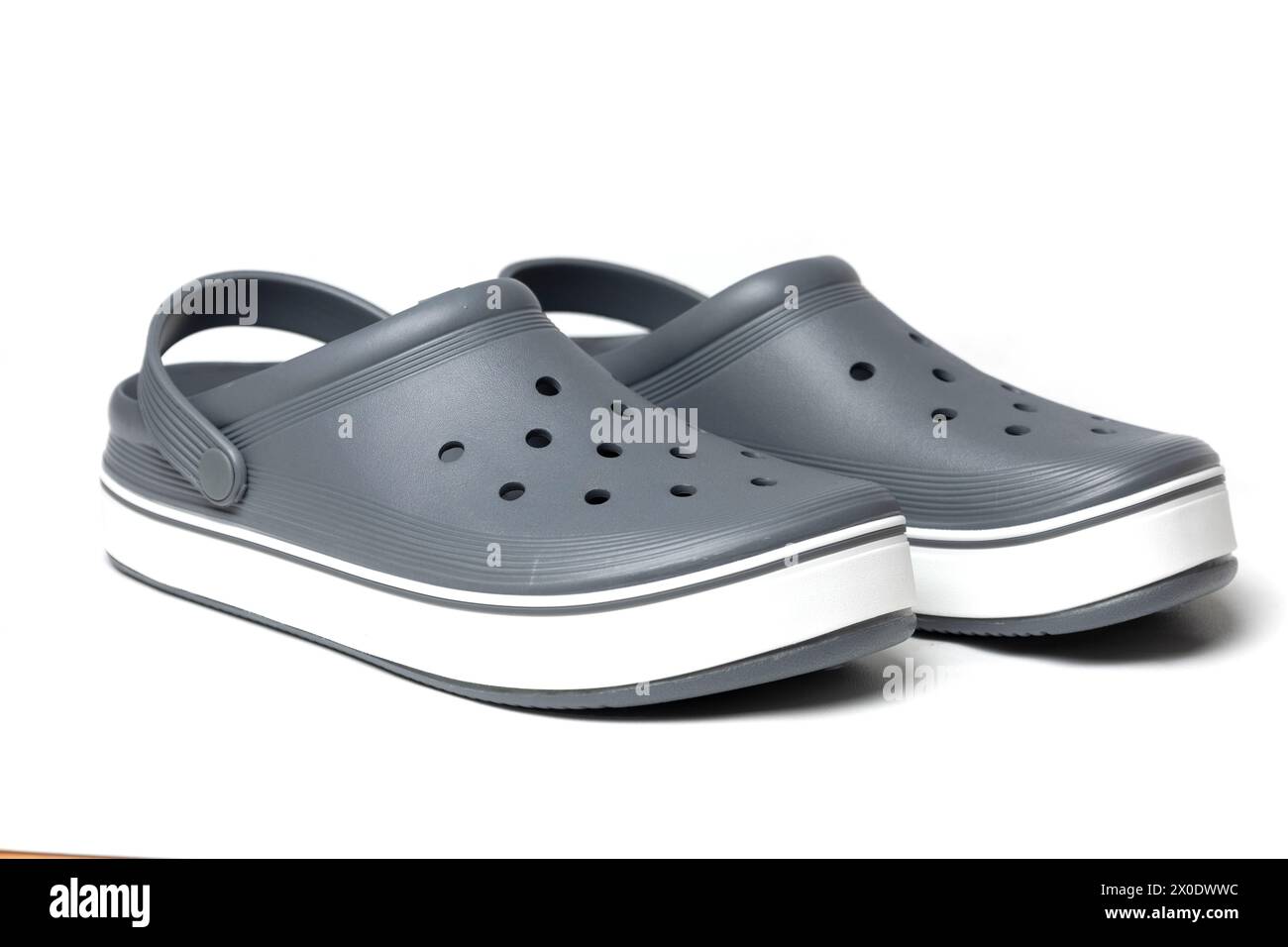 Gray crocs on a white background. Rubber shoes Stock Photo - Alamy