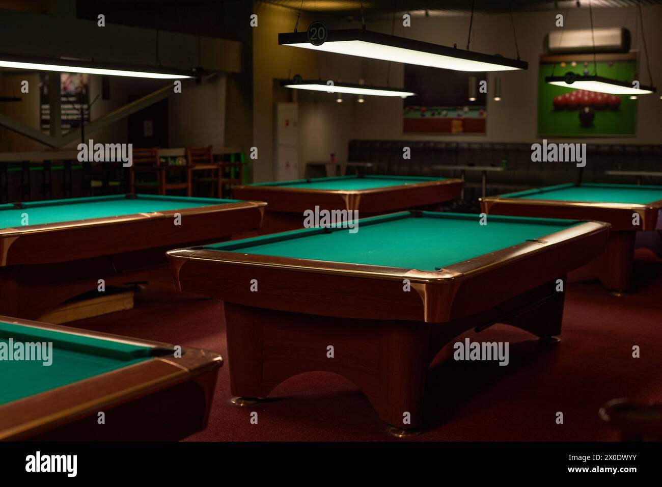 Background image of several billiard tables in underground gaming area ...
