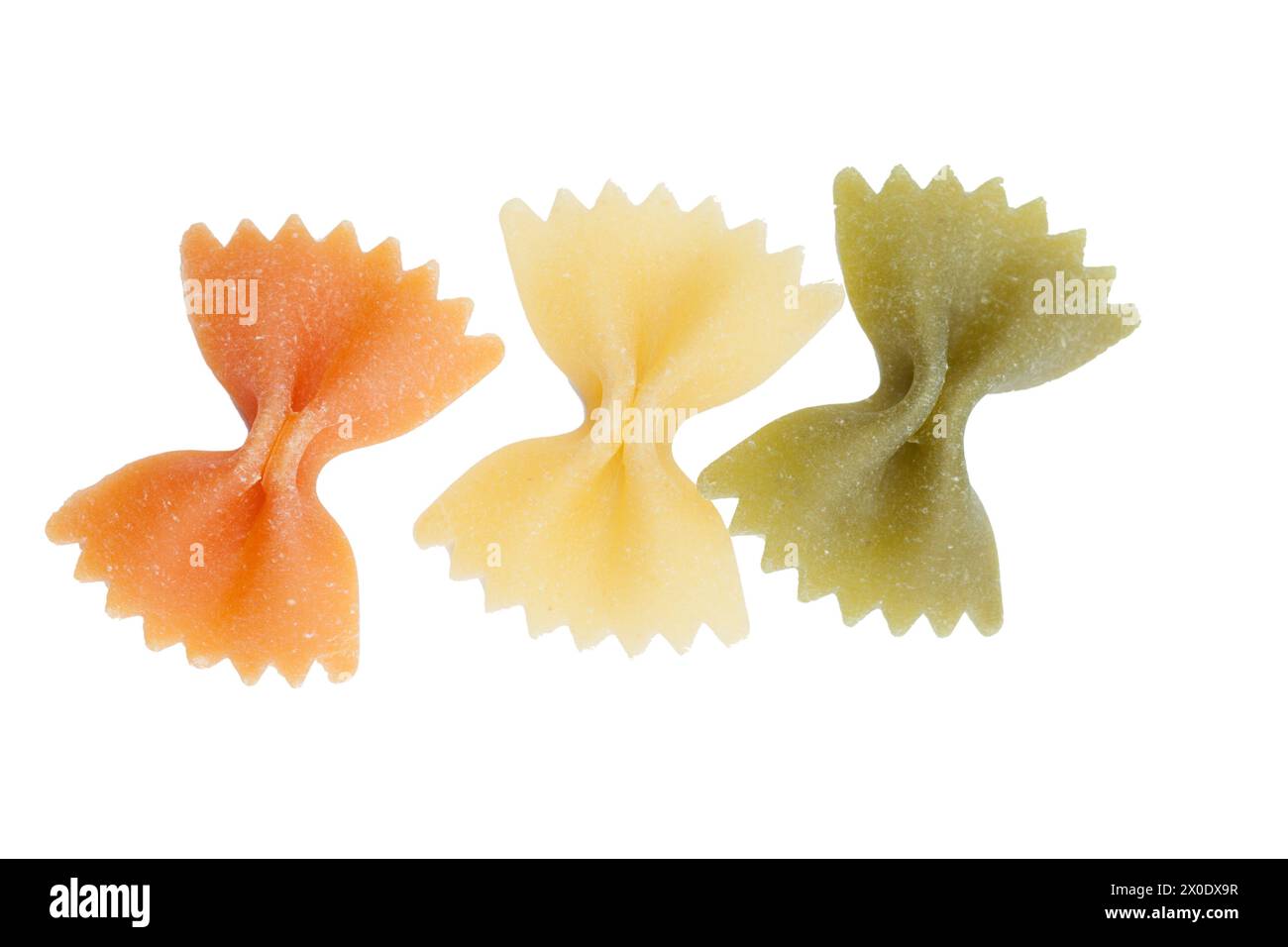 Three samples of different colors of farfalle pasta. Isolated over ...