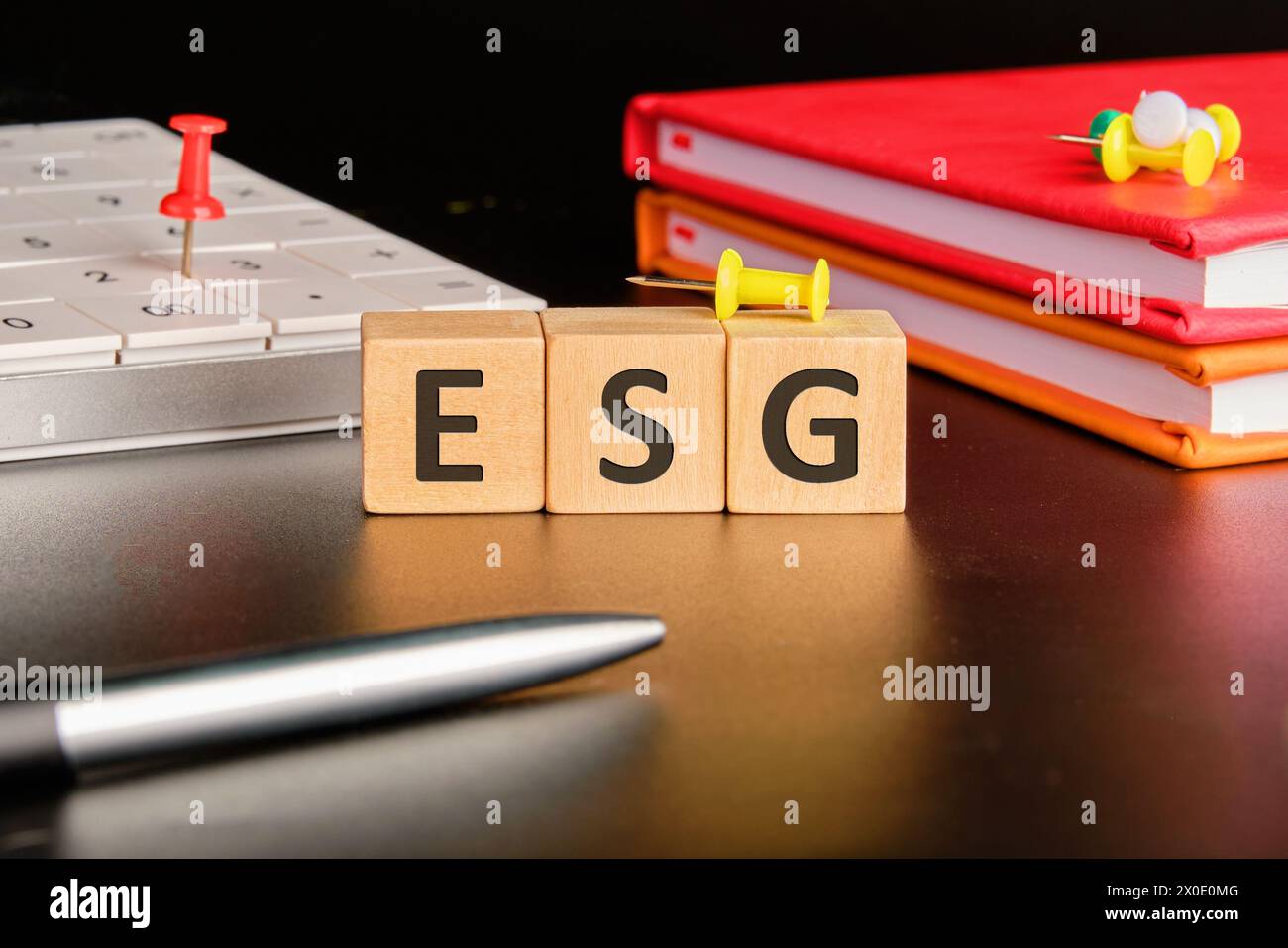 ESG concept of environmental, social and governance. words ESG on wooden cubes with a calculator ...