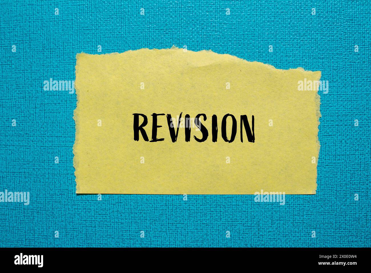 Revision word written on ripped yellow paper with blue background ... Revision word written on ripped yellow paper with blue background ...