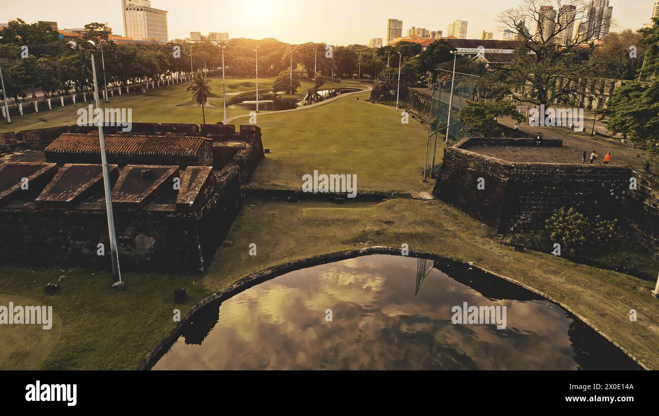 Pond with sun reflection at designed green park aerial. Green grass ...