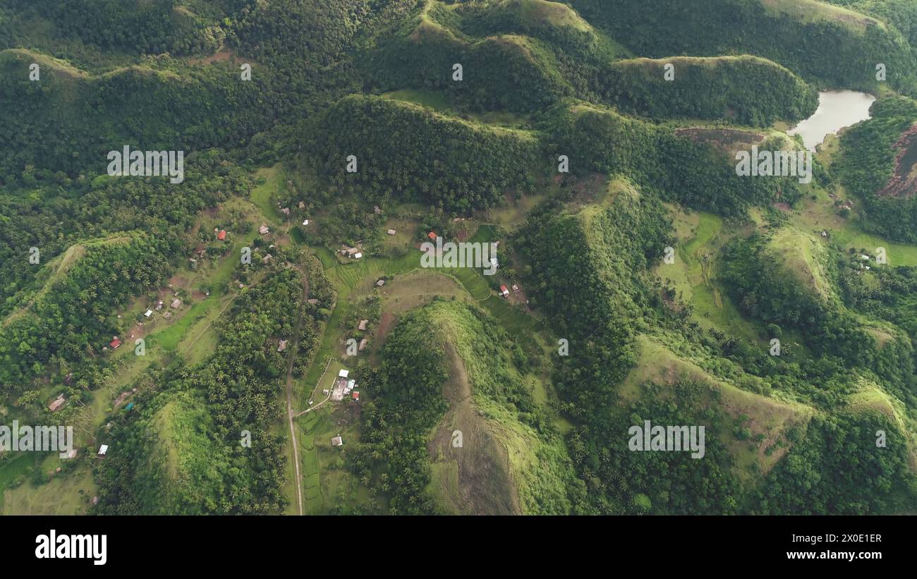 Rural green mountains ranges aerial view: greenery road and cottages at ...