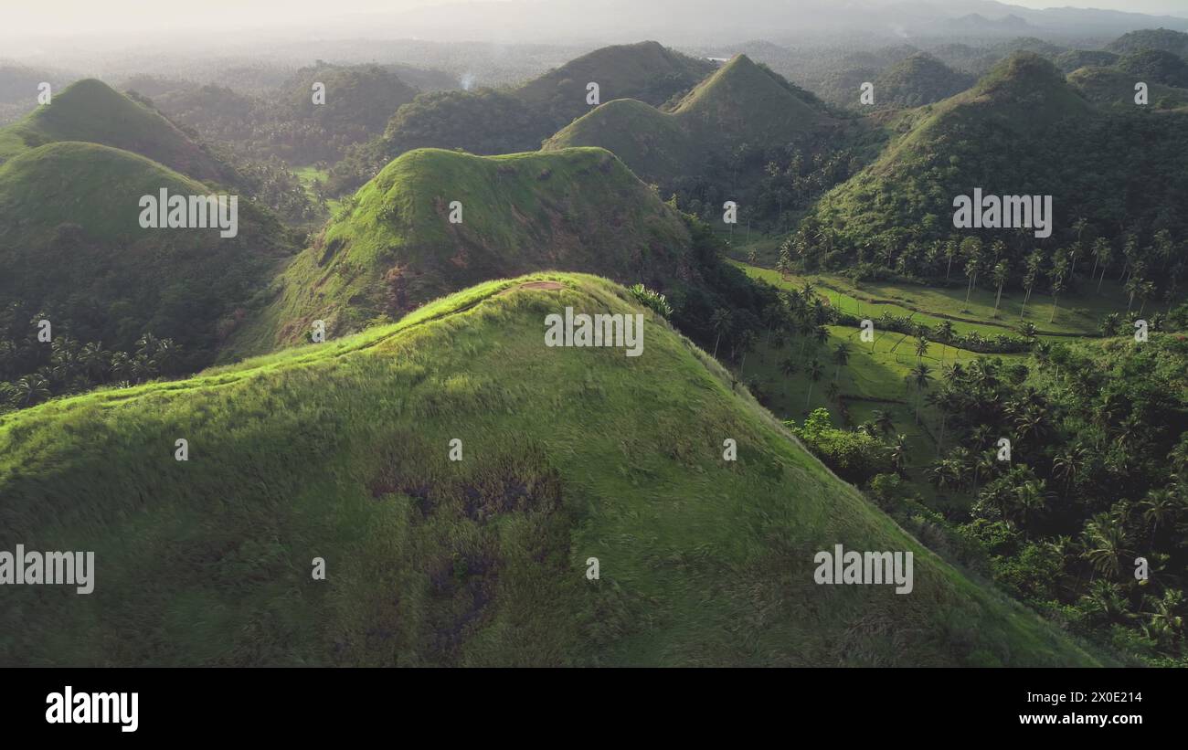 Philippines hilly countryside aerial: misty haze over mountain ranges ...