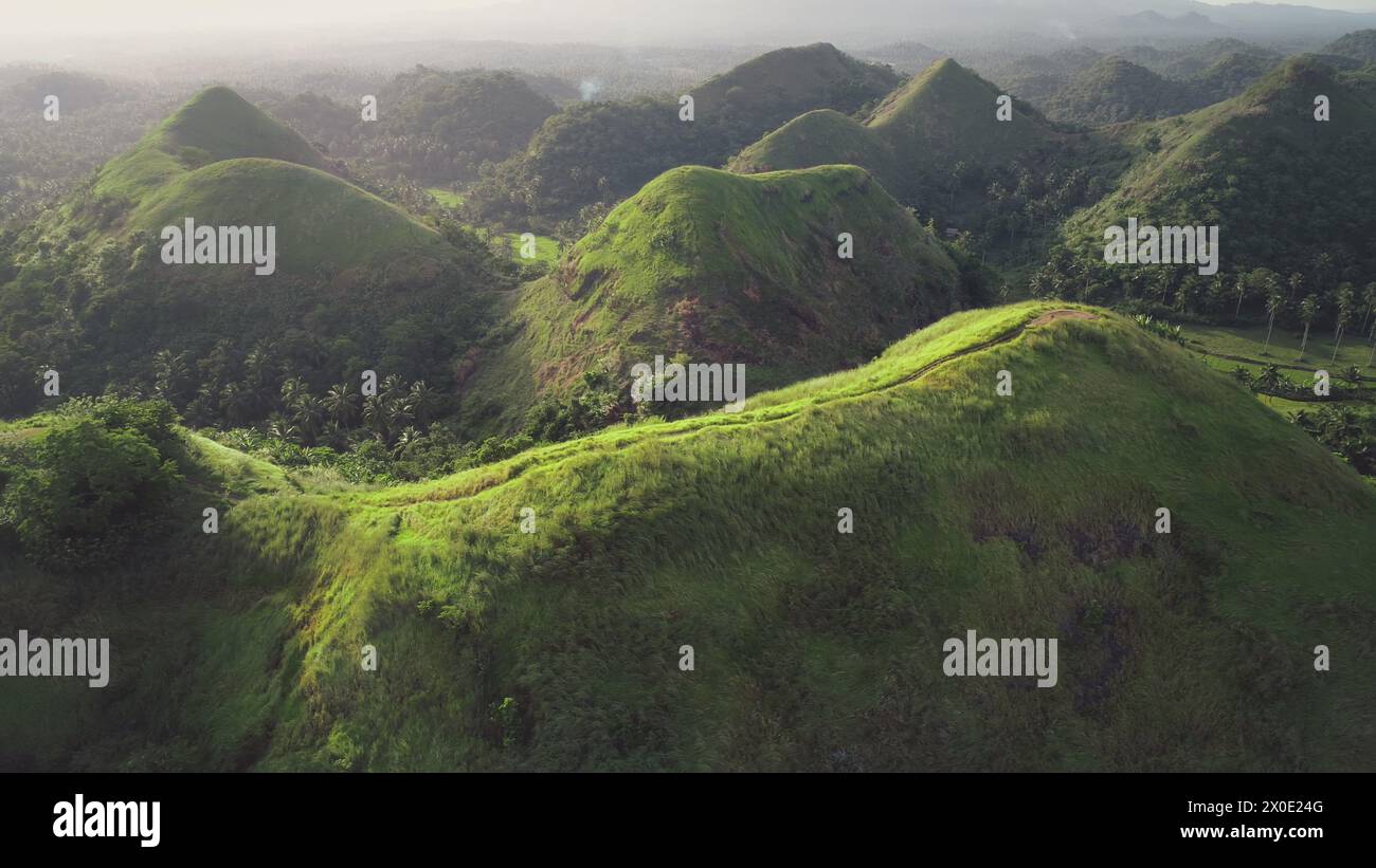 Philippines mountains ranges aerial: building at peak with hiking path ...