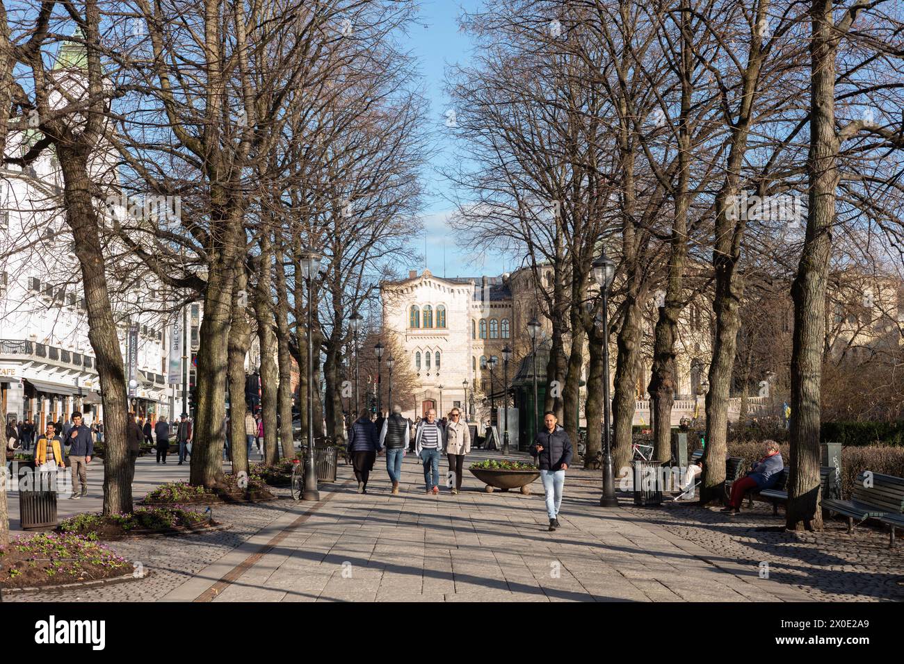 Pedestrians walk along the tree lined Karl Johan Gate, on a sunny ...