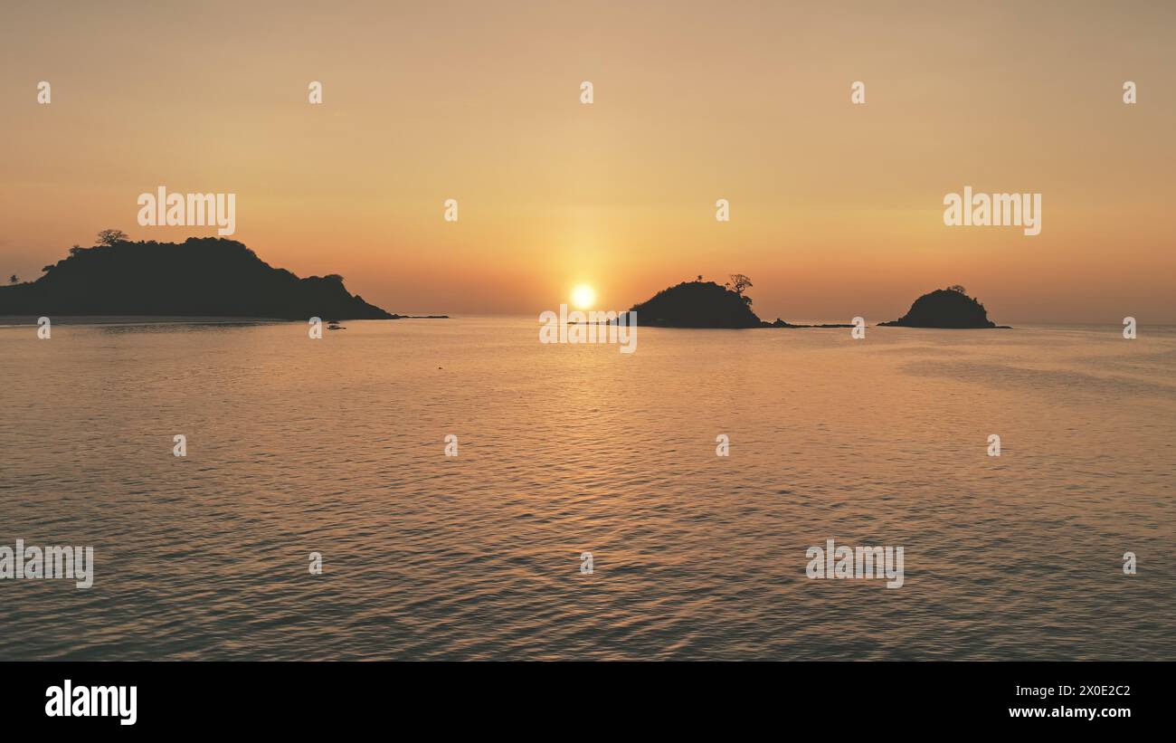 Timelapse of sunset seascape at mountain island silhouette aerial ...