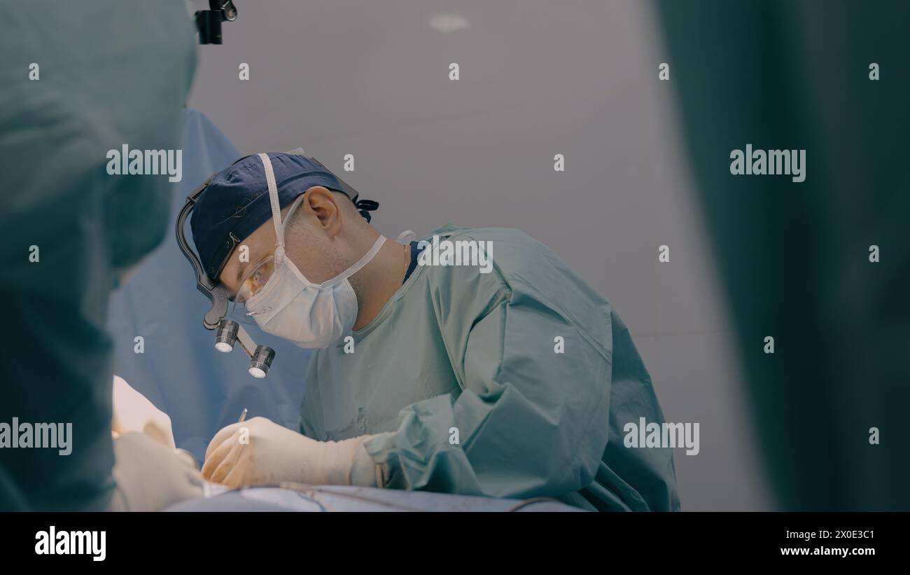 Surgeon man practitioner with team assistants perform surgical ...