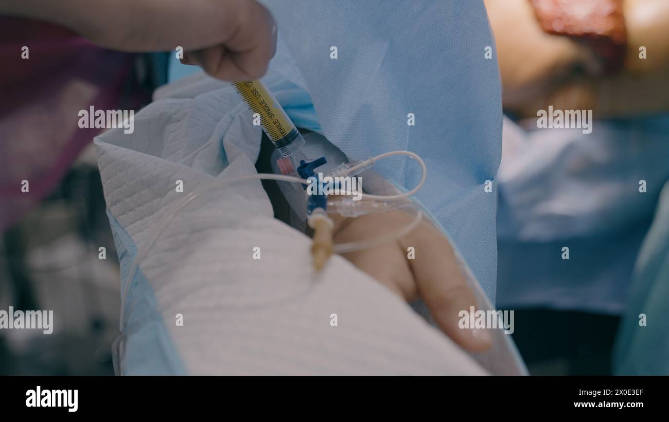 Close up hands doctor nurse inject iv anesthesia in catheter ...