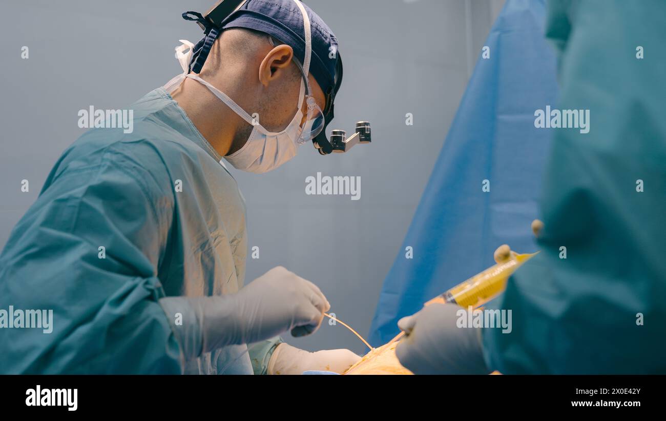 Doctor man physician surgeon perform plastic surgery liposuction ...