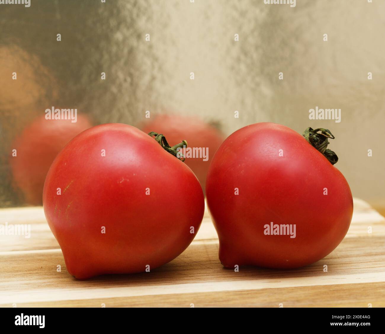 Round Pink tomato with a nose that produces heart shape when cut in ...