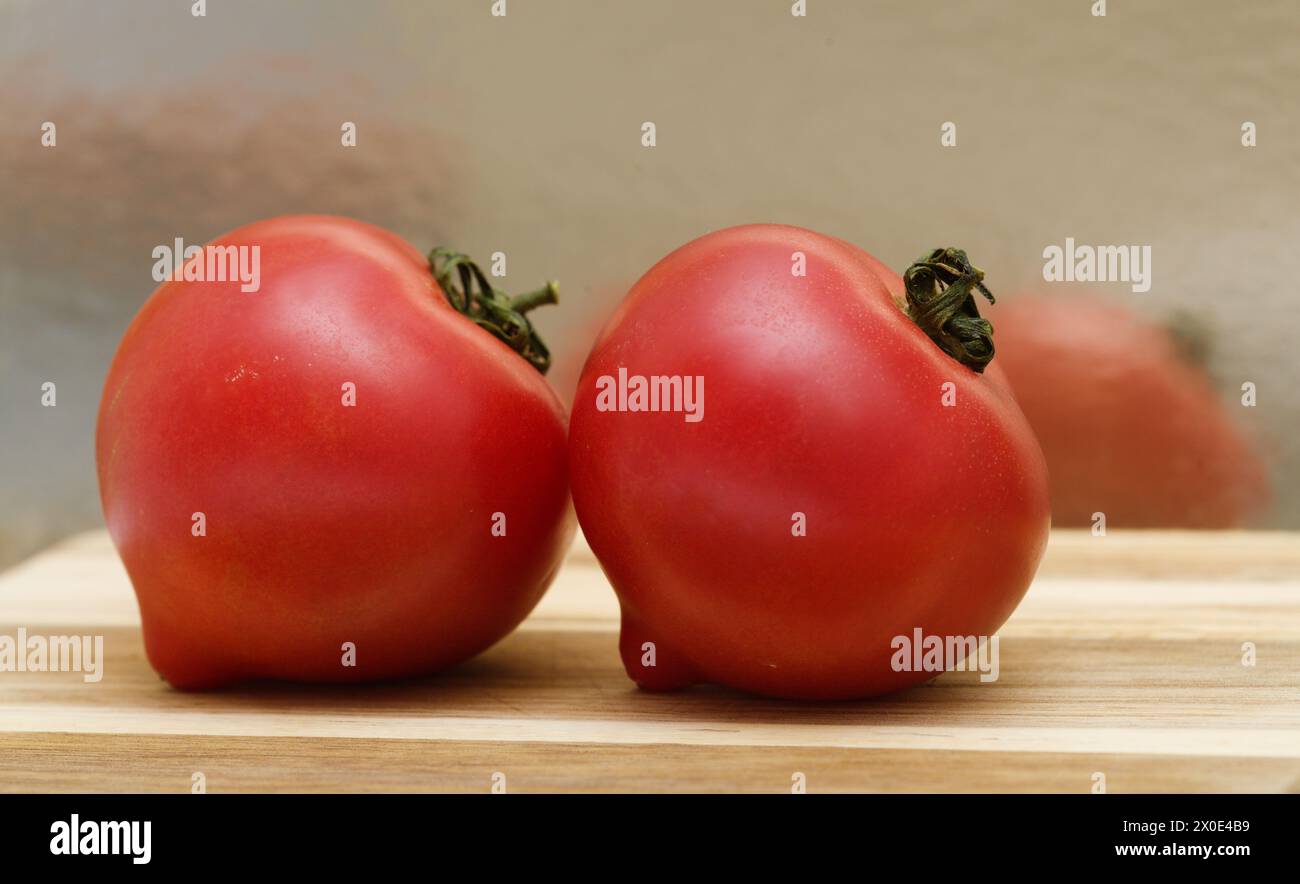 Round Pink tomato with a nose that produces heart shape when cut in ...