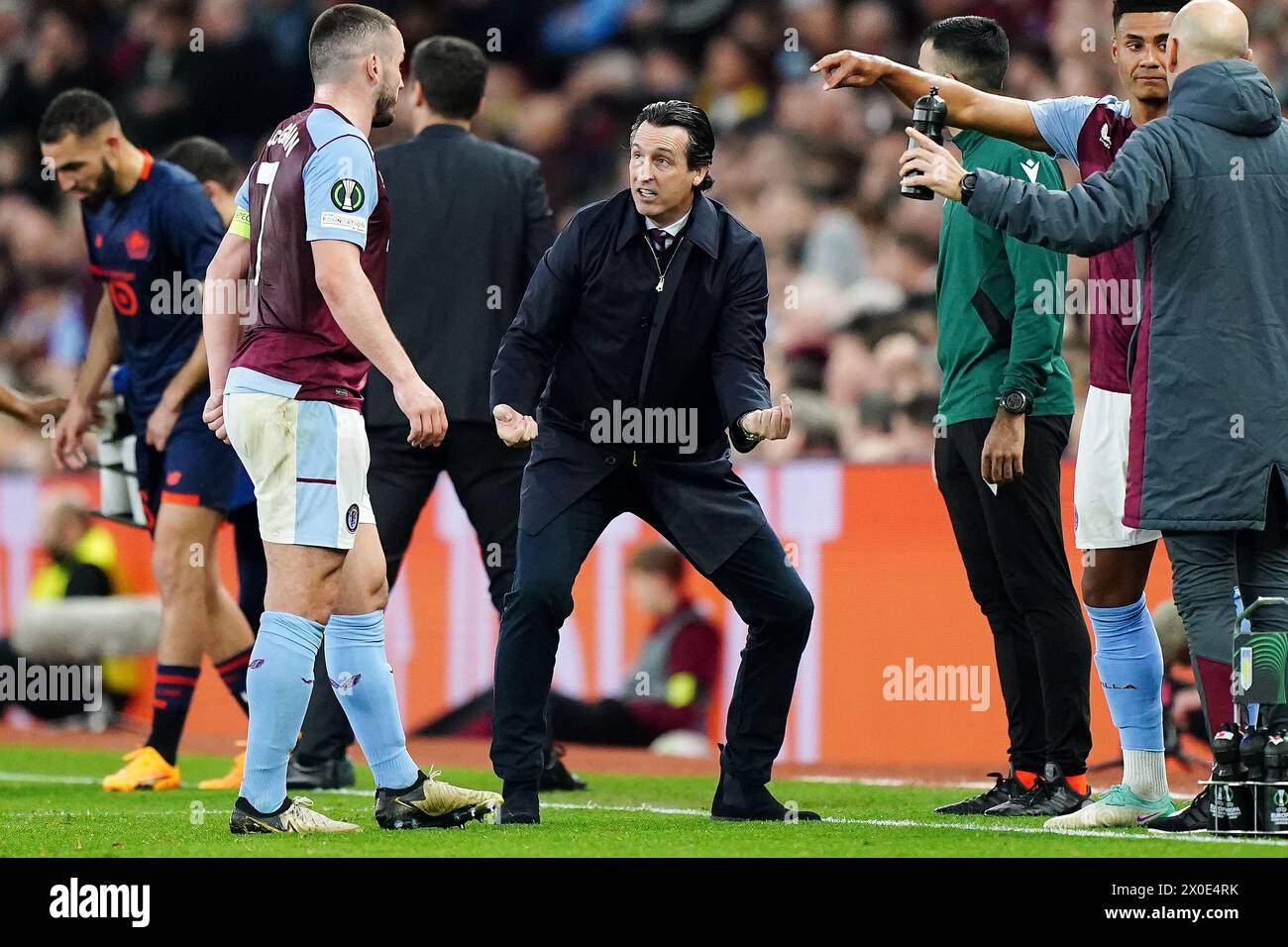 Aston Villa manager Unai Emery (centre) gestures on the touchline ...