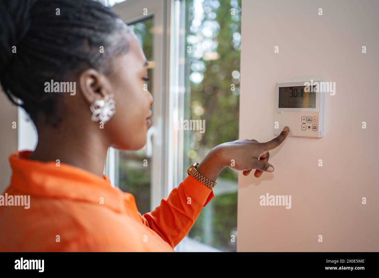 Woman Turning On Light Switch Stock Photo - Alamy