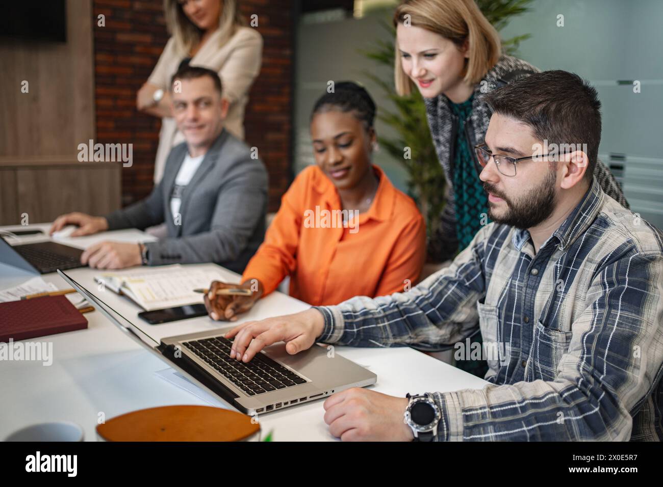 Group of People Working on Laptops at Table Stock Photo - Alamy