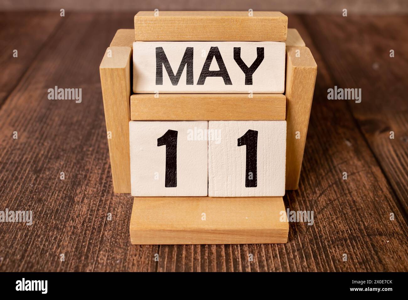 11 Mai on wooden grey cubes. Calendar cube date 11 May. Concept of date ...