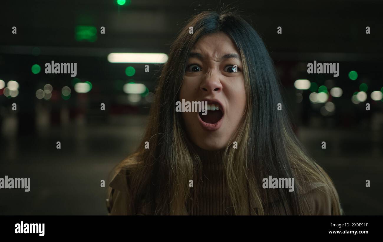 Mad angry crazy Asian korean chinese japanese girl shout in car parking ...