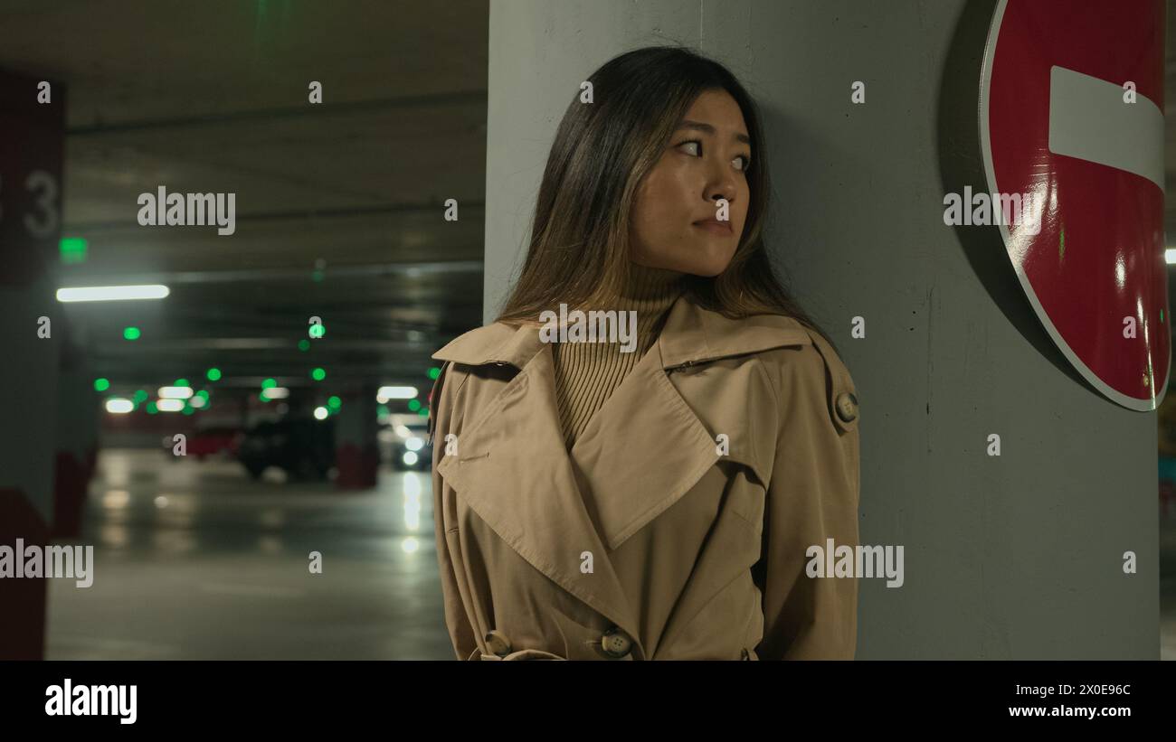 Frightened Asian ethnic chinese korean woman hiding from danger pursuit ...