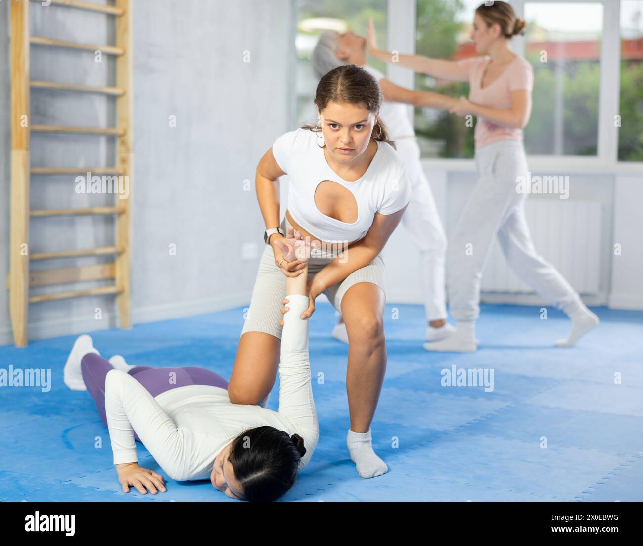 Young woman practicing armlock in training bout during self defence course Stock Photo - Alamy