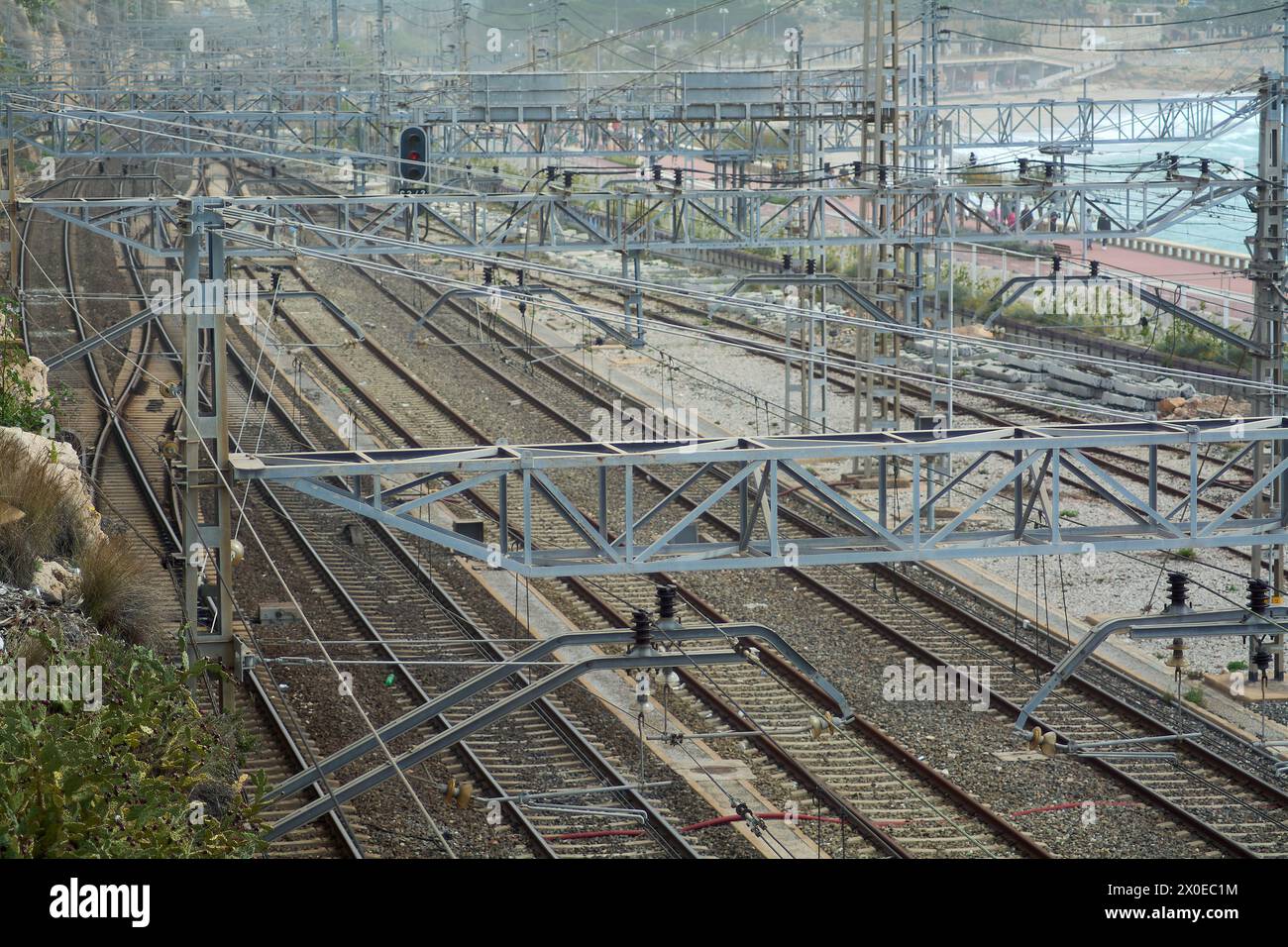 Detailed aerial view of multiple crisscrossing railroad tracks, surrounded by a network of ...